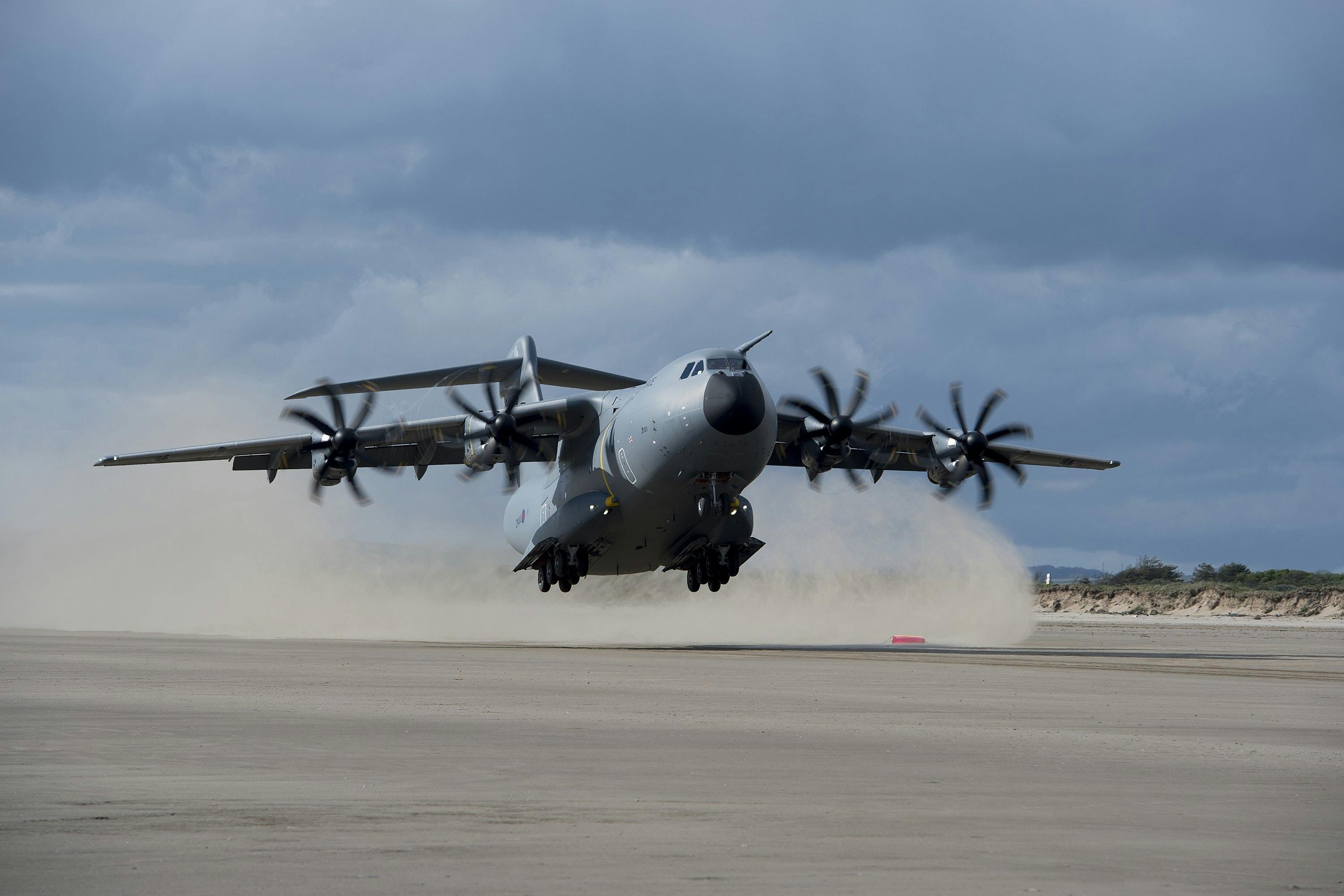 Huge RAF A400M transport aircraft lands on beach at night